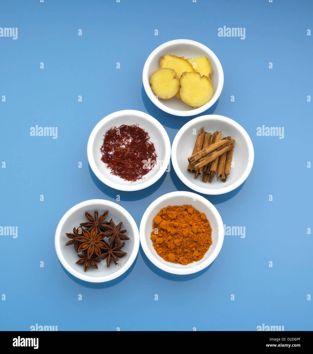 Five small bowls of mixed spices cut out blue background Stock Photo ...