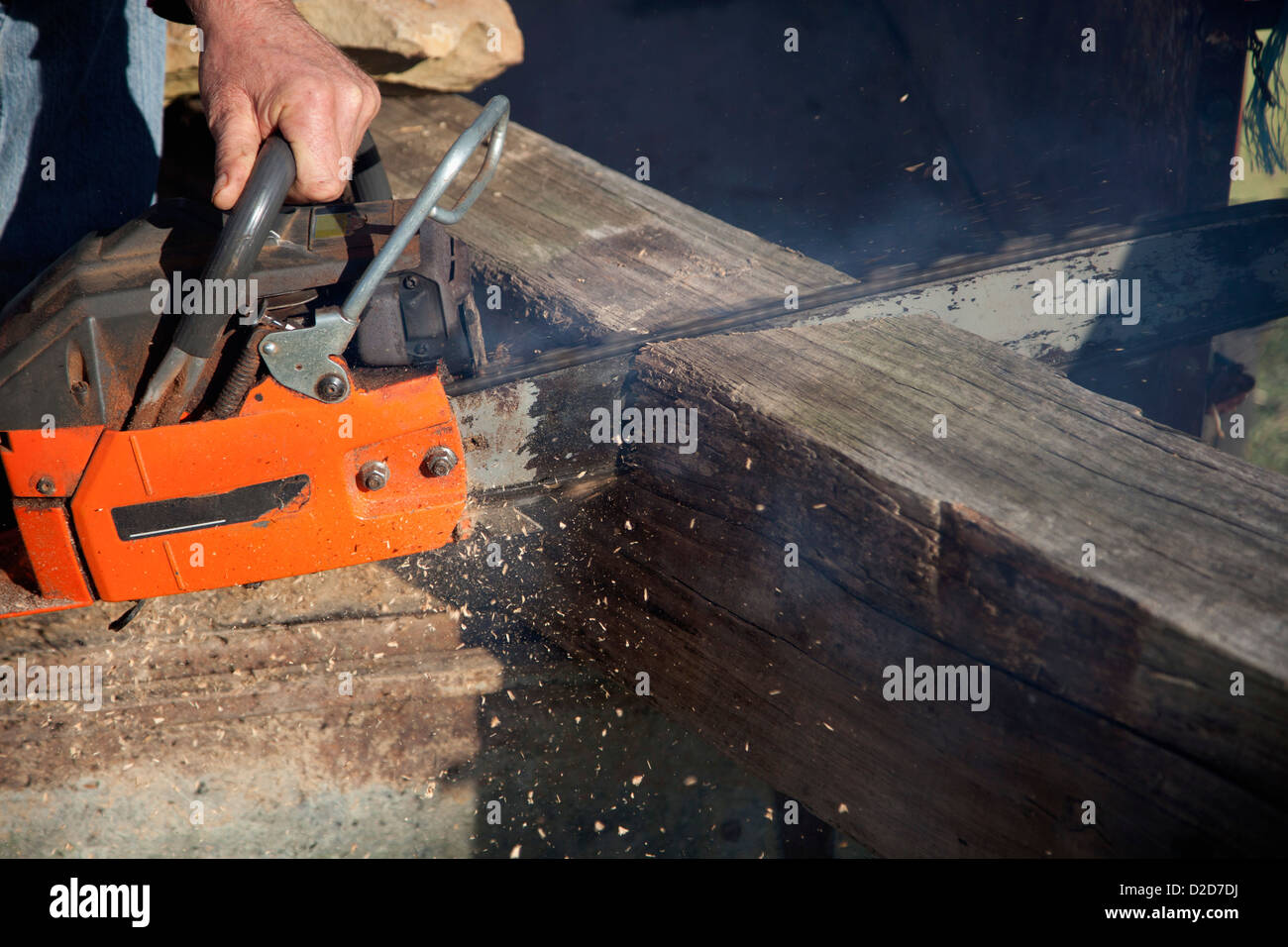 Detail of a man cutting wood with a chainsaw Stock Photo - Alamy