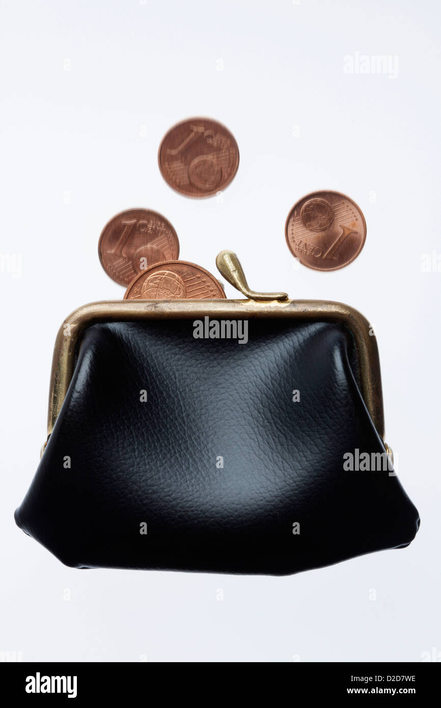 Coins falling into purse Stock Photo - Alamy