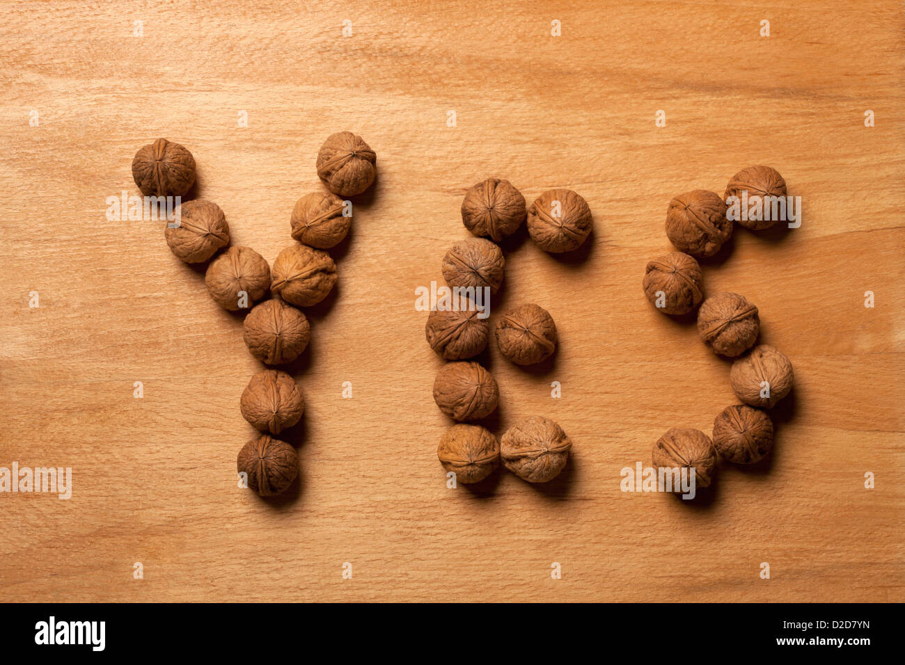 Single word 'yes' spelled with walnuts Stock Photo - Alamy