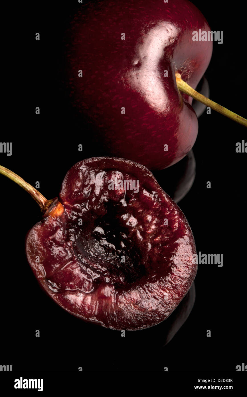 A half of a Bing cherry lying next to a whole cherry Stock Photo - Alamy
