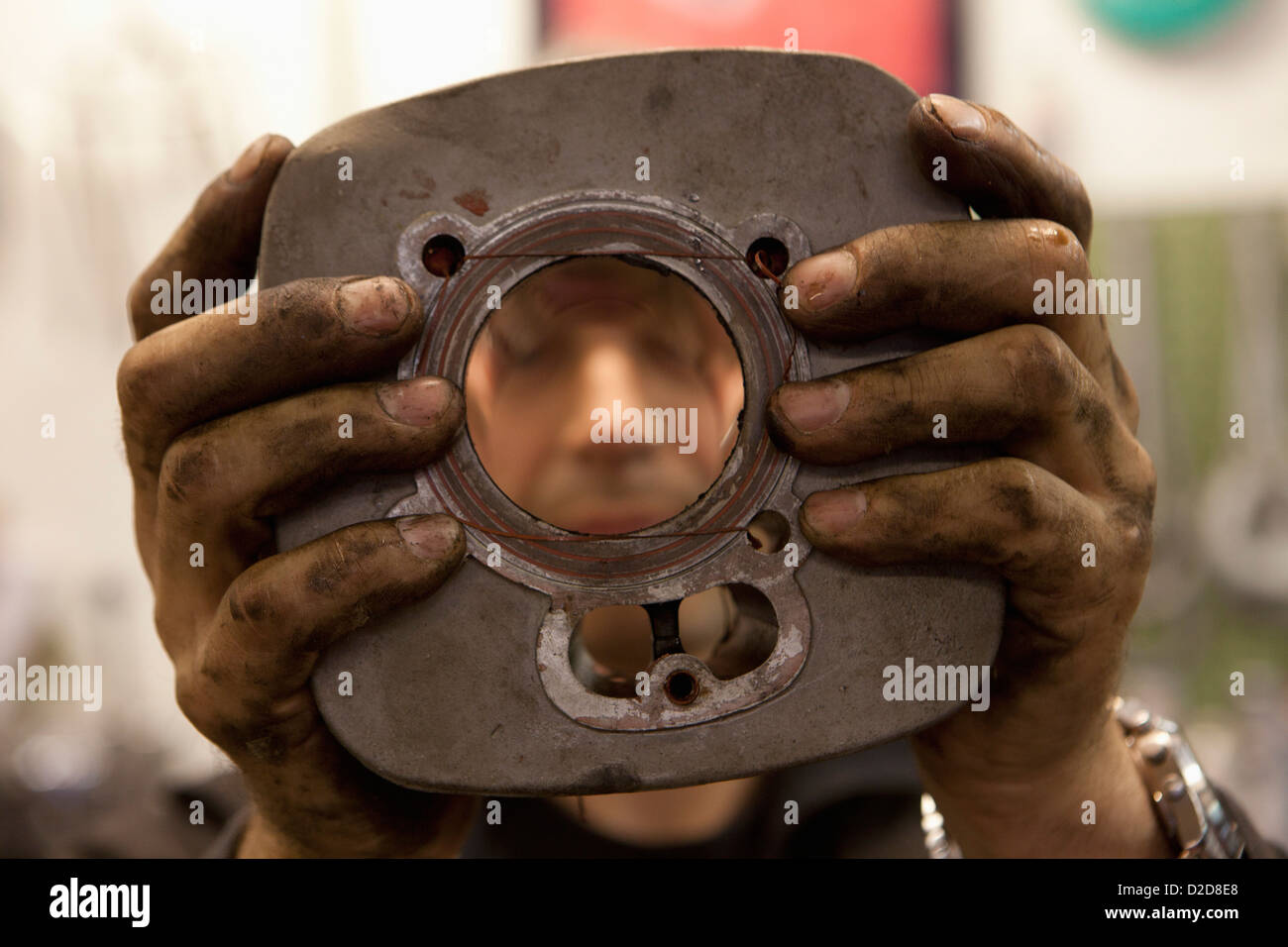 Mechanic showing motorcycle cylinder Stock Photo - Alamy
