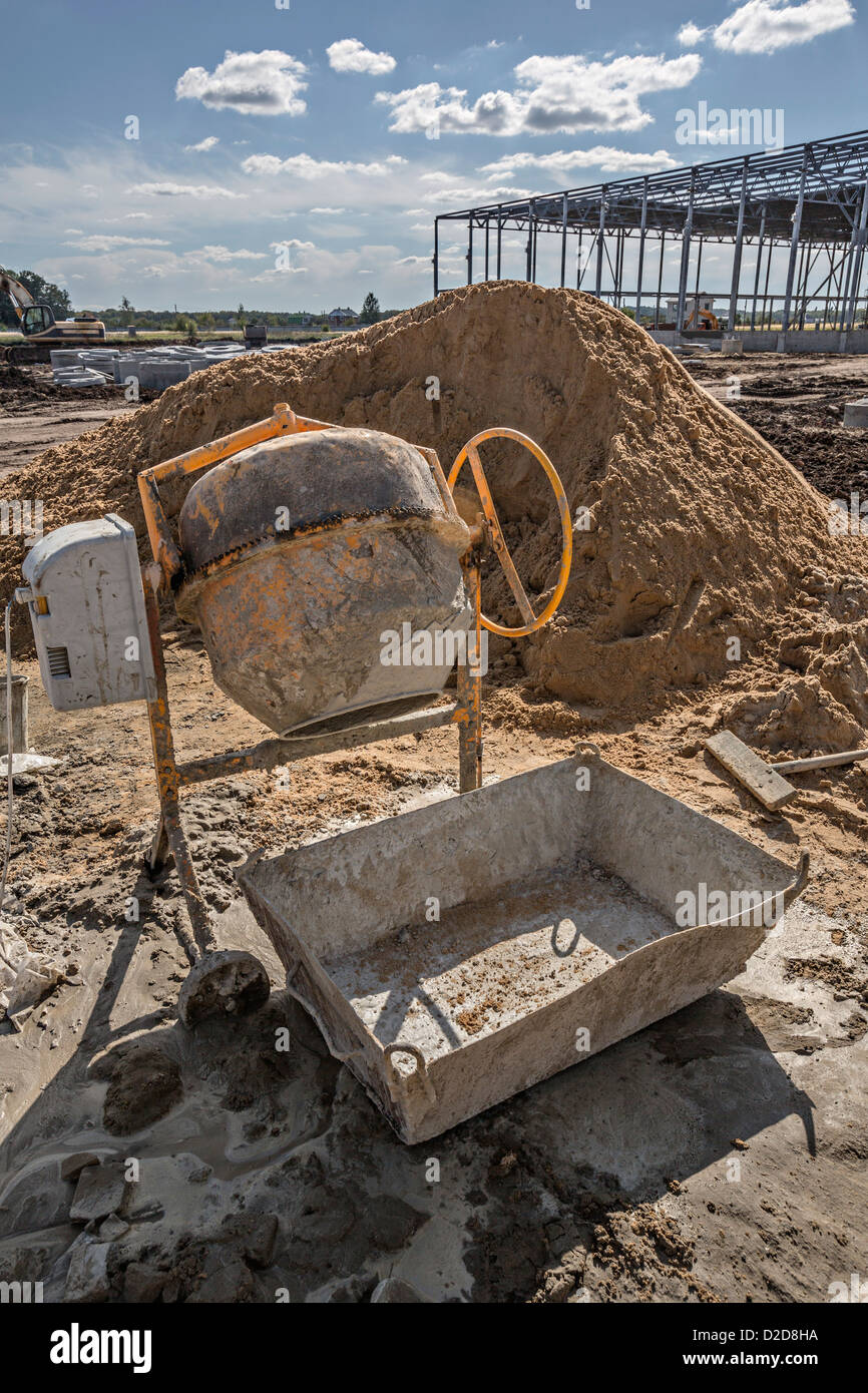 Cement mixer and sand heap at construction site Stock Photo - Alamy