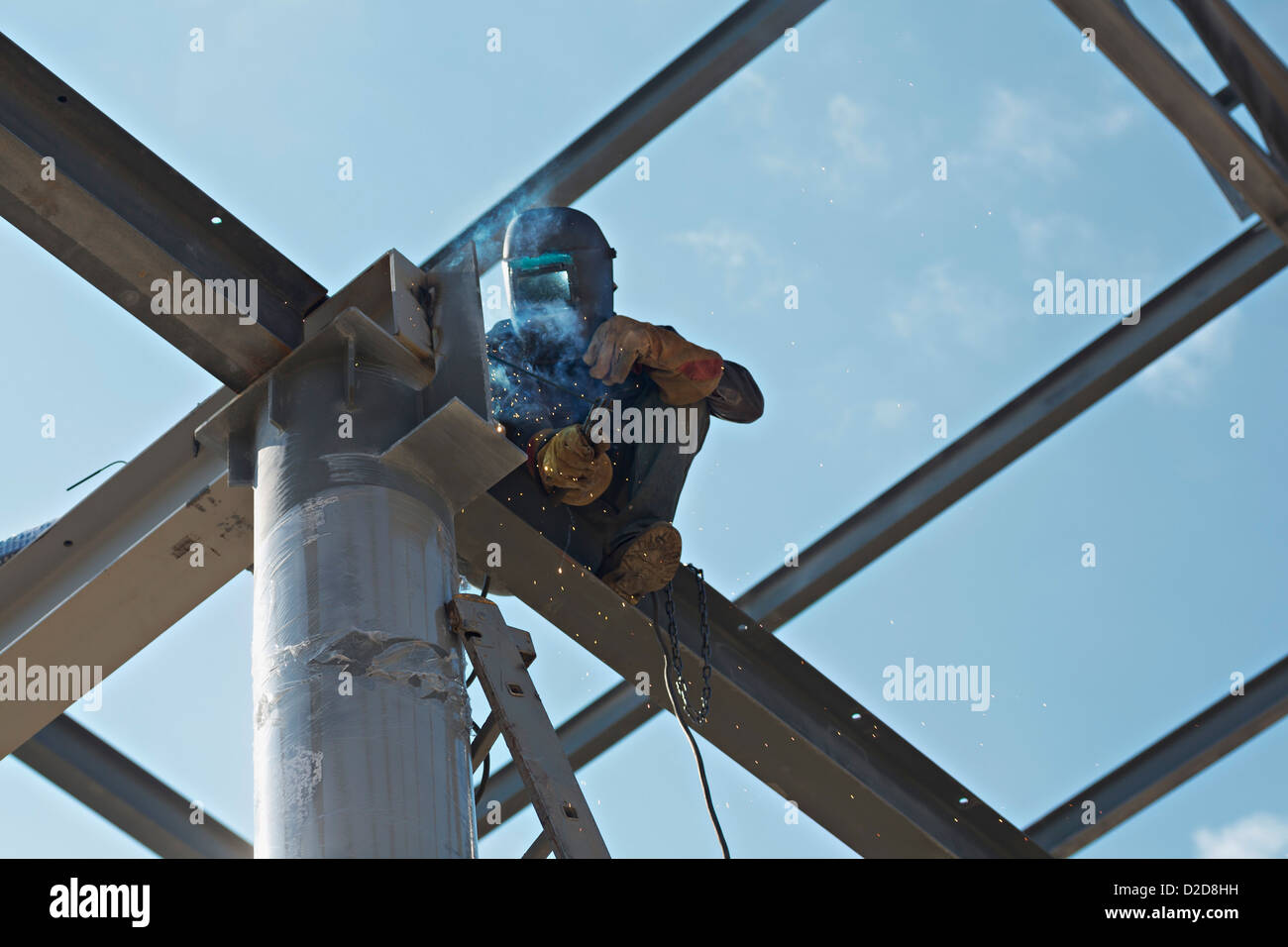 Welder high up on steel beam Stock Photo - Alamy