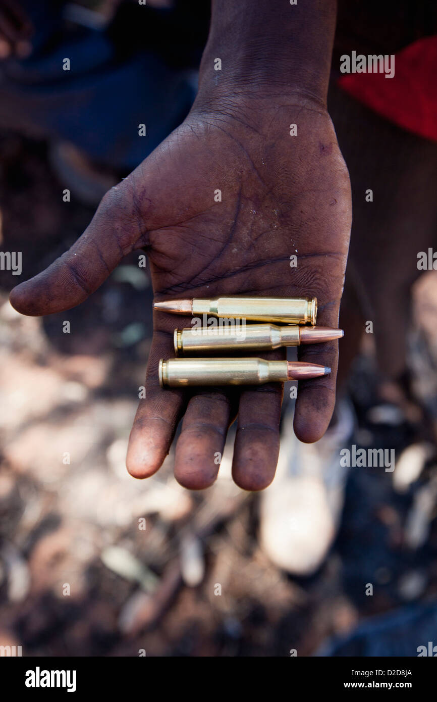Detail of a man holding three bullets Stock Photo - Alamy