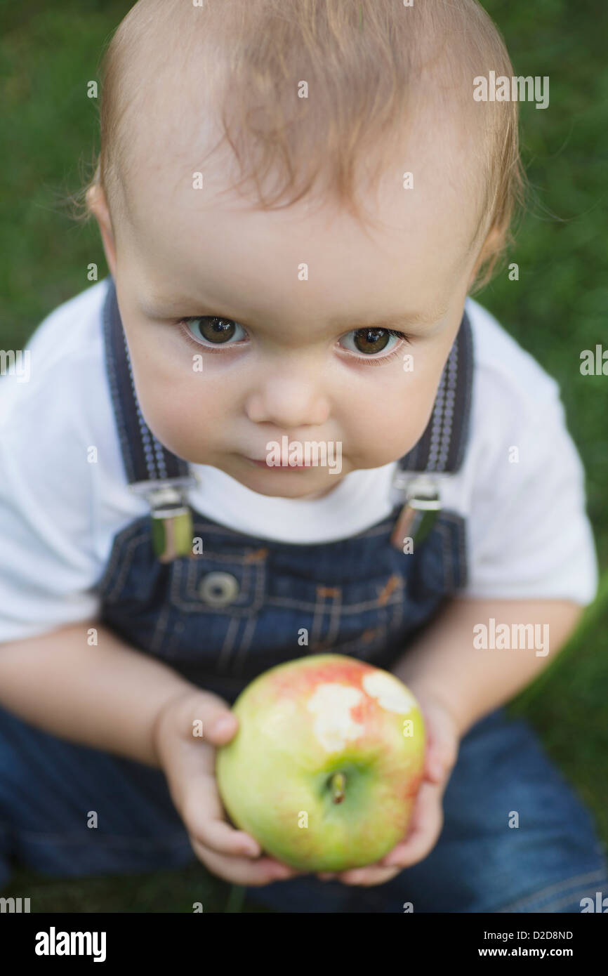 Baby holding apple Stock Photo - Alamy