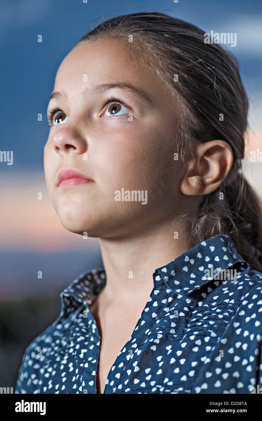 A girl looking up contemplatively, close-up Stock Photo - Alamy