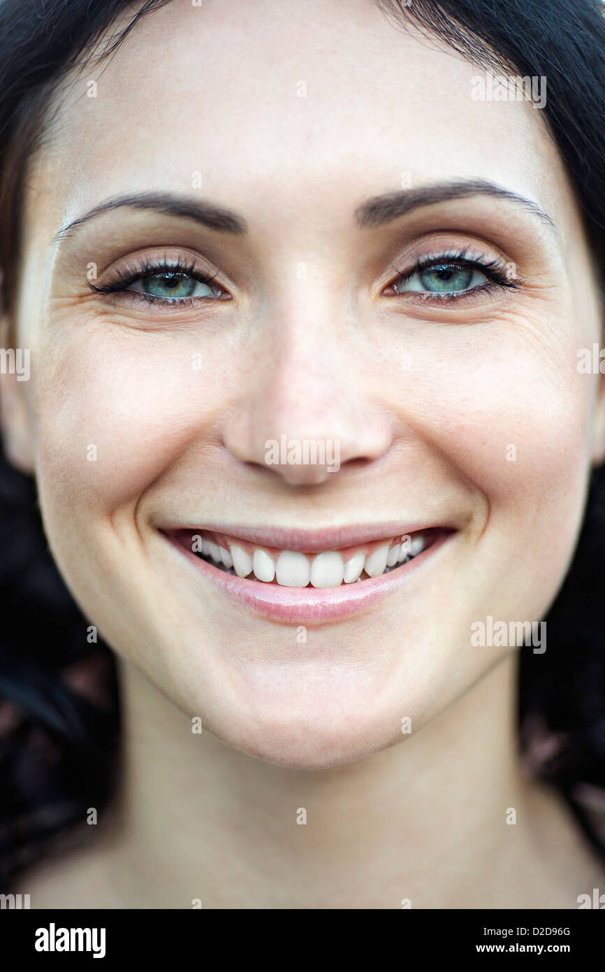 A beautiful young woman grinning into the camera Stock Photo - Alamy
