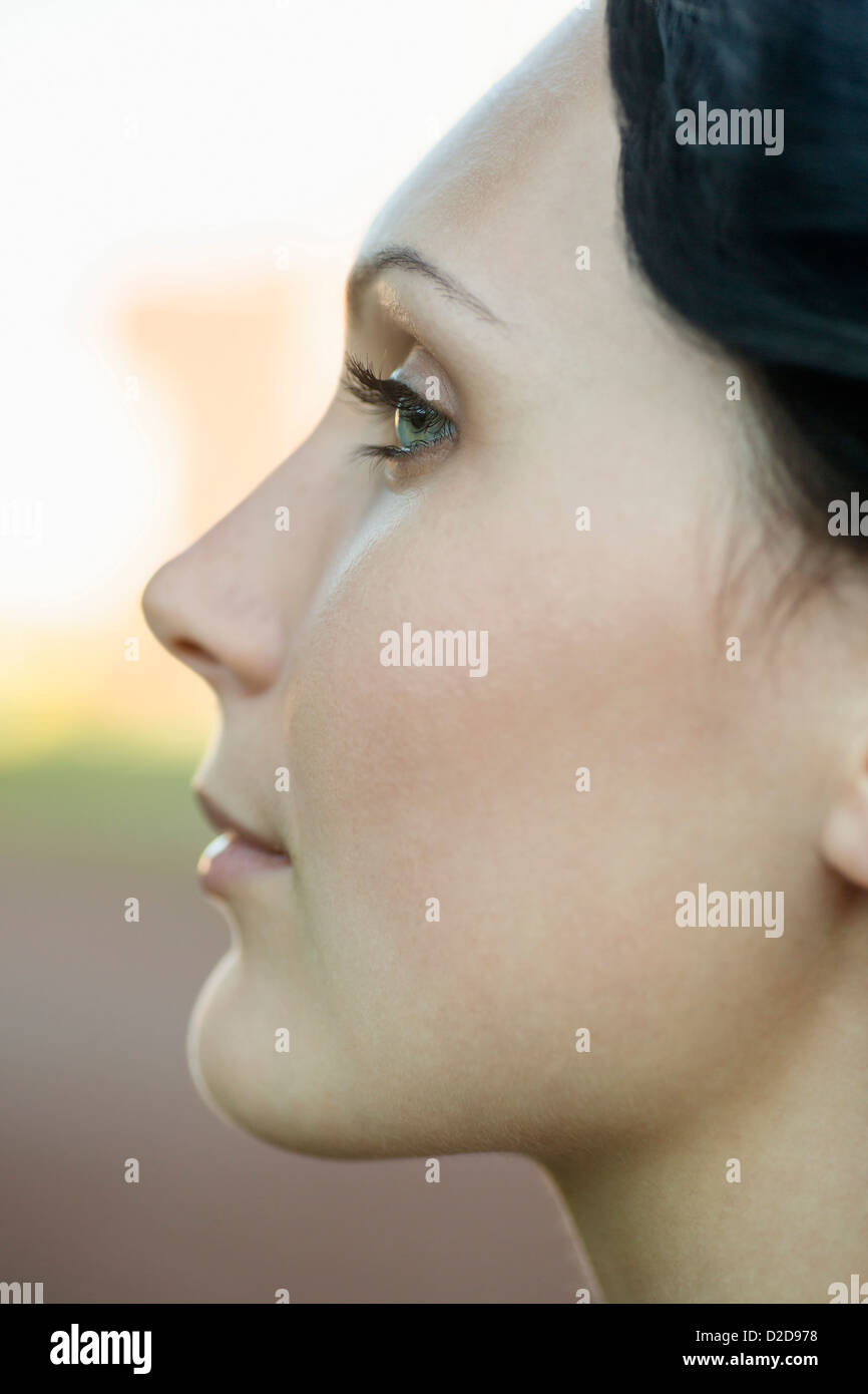 A beautiful young woman looking thoughtfully off camera Stock Photo - Alamy