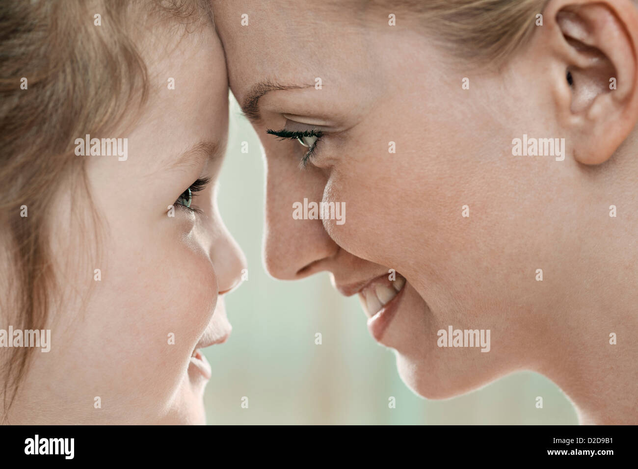 Smiling mother daughter touching foreheads hi-res stock photography and ...