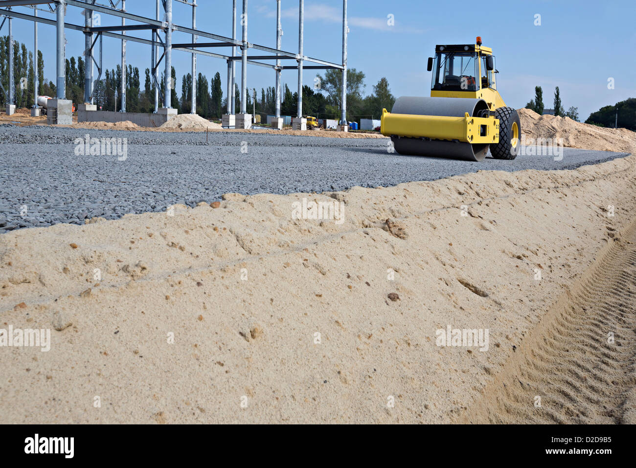 A gravel road steamroller next to a construction frame Stock Photo - Alamy