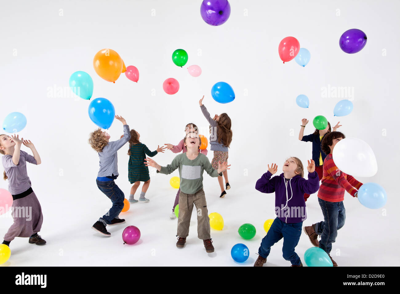 A group of kids playing with balloons Stock Photo - Alamy