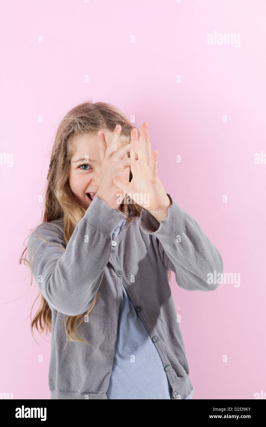 A girl gesturing with her hands playfully and laughing Stock Photo - Alamy