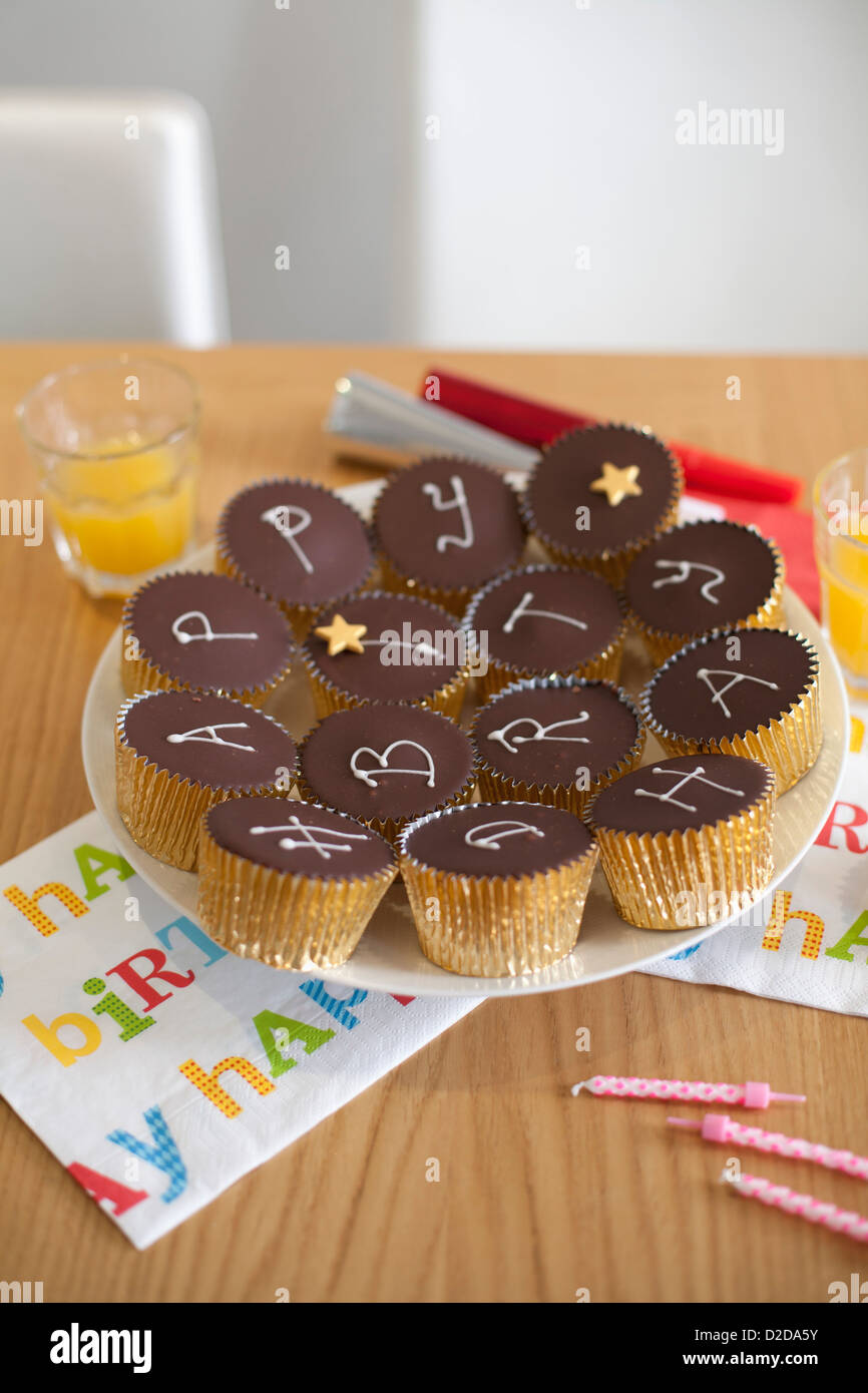 A plate of cupcakes with Happy Birthday written on them Stock Photo - Alamy