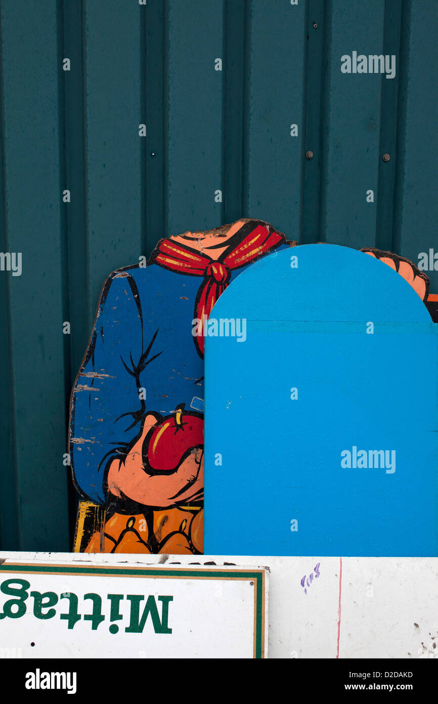 Old commercial signs leaning against a building Stock Photo - Alamy