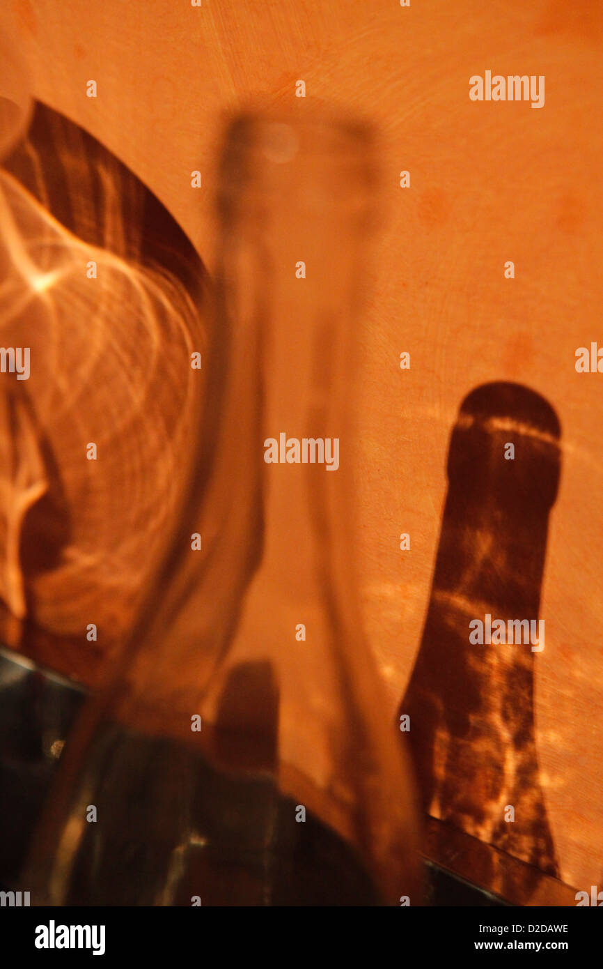 Light refraction and a glass bottle shadow making an abstract pattern ...