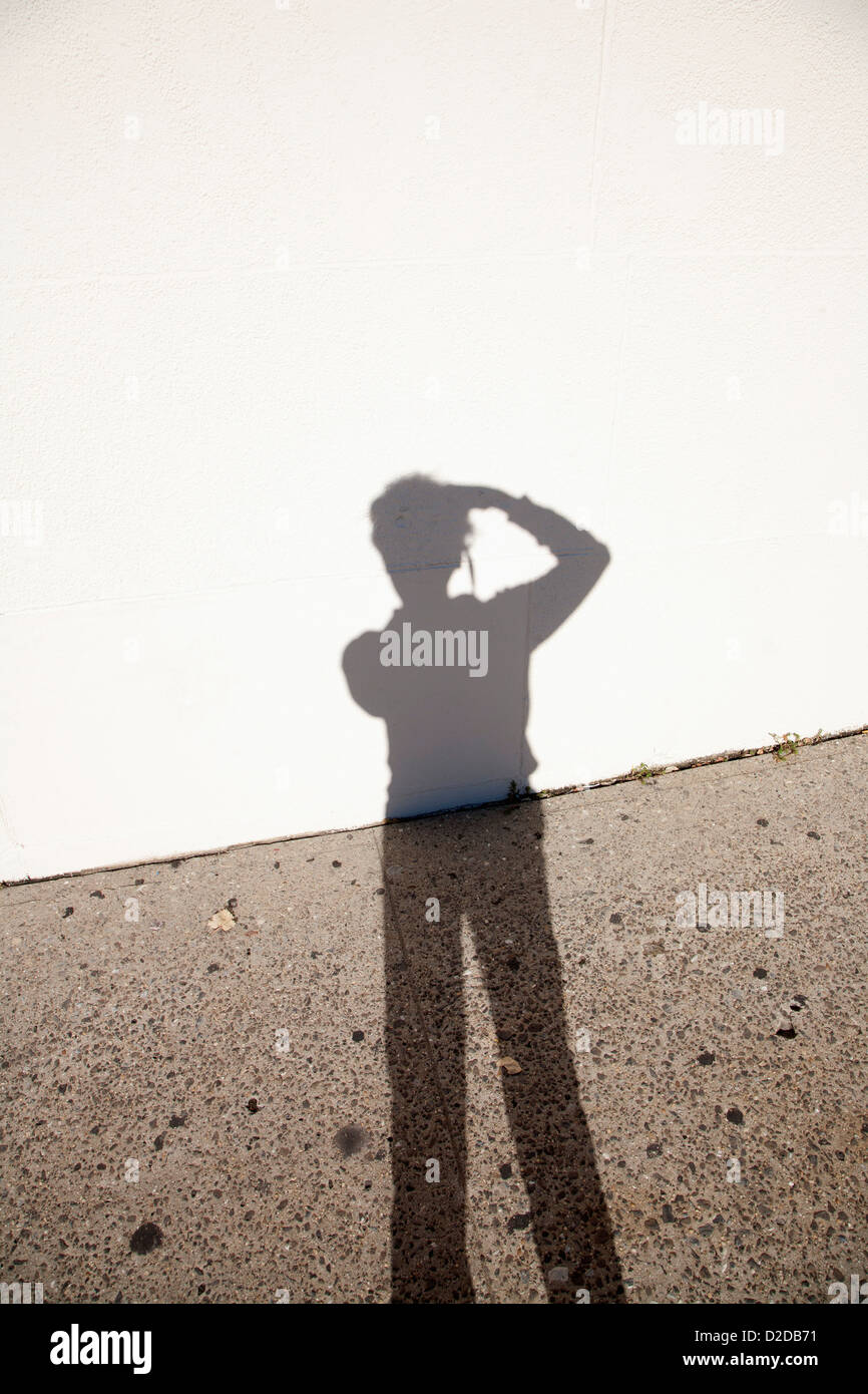 Photographer's shadow against ground and wall Stock Photo - Alamy
