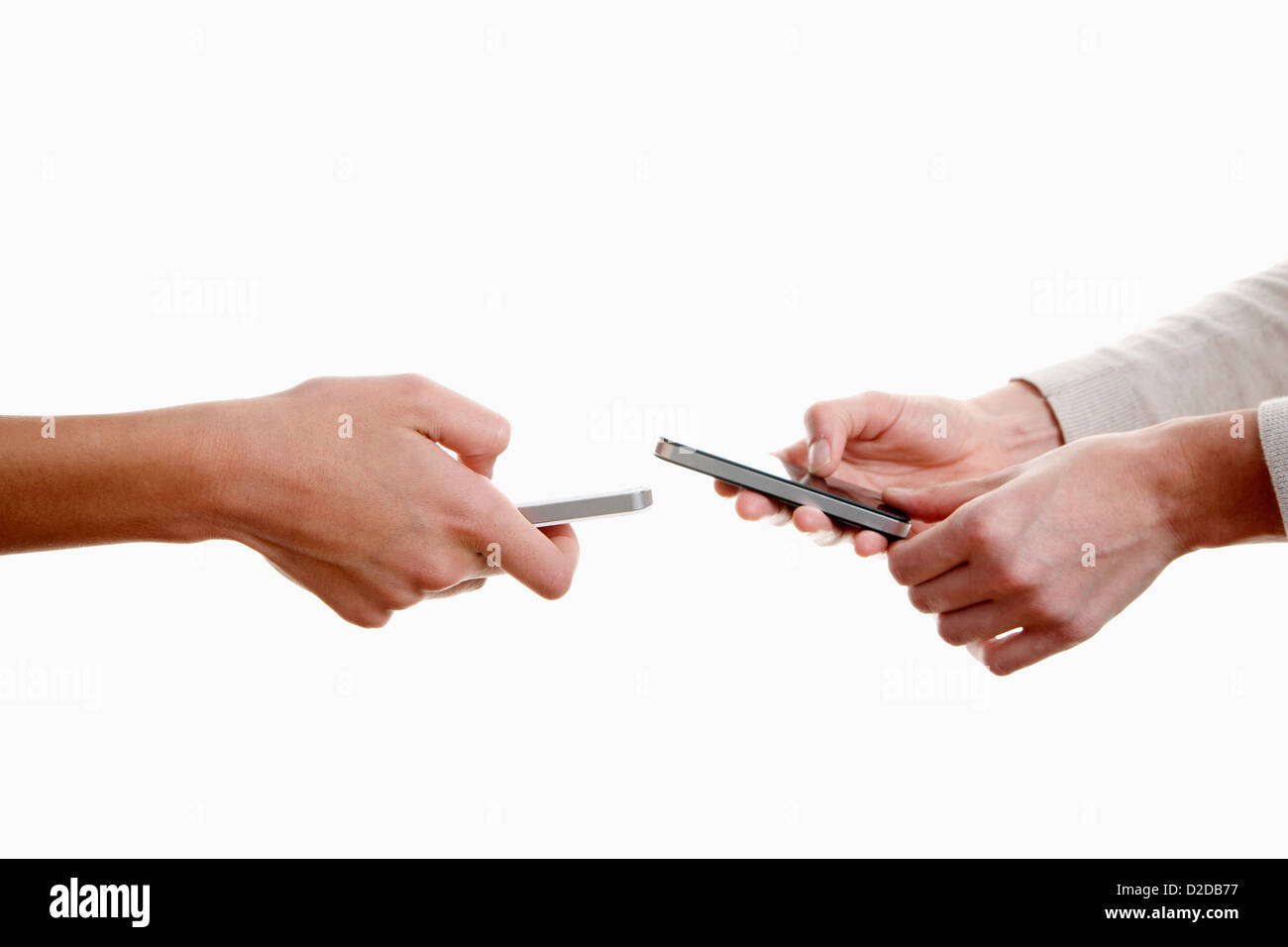 Two women using their phones Stock Photo - Alamy