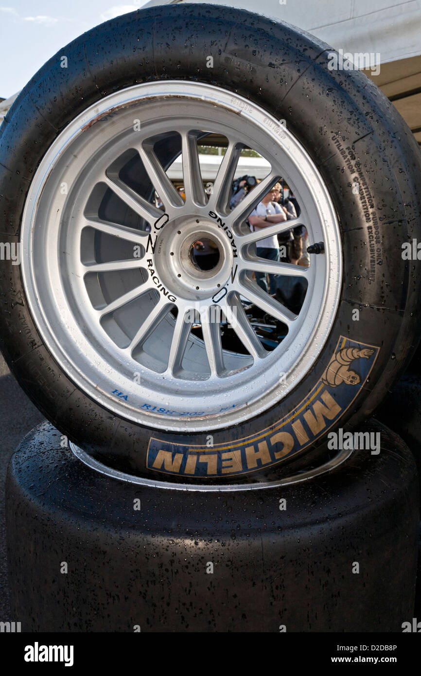 Racing wheel with tyre standing upright on another Stock Photo - Alamy