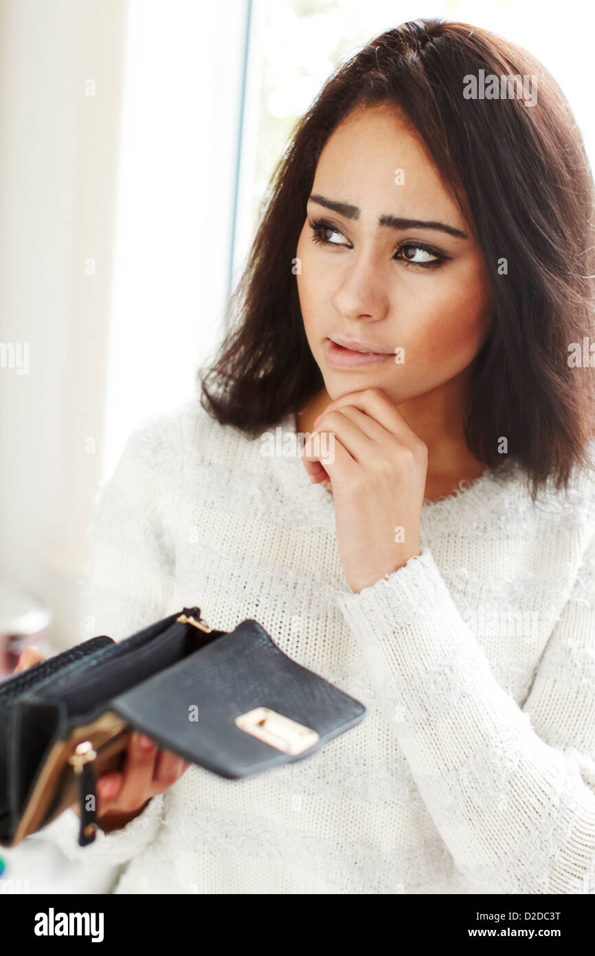 Girl looking in purse Stock Photo - Alamy