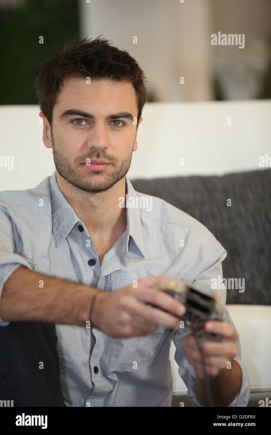 Young man playing video games alone Stock Photo - Alamy