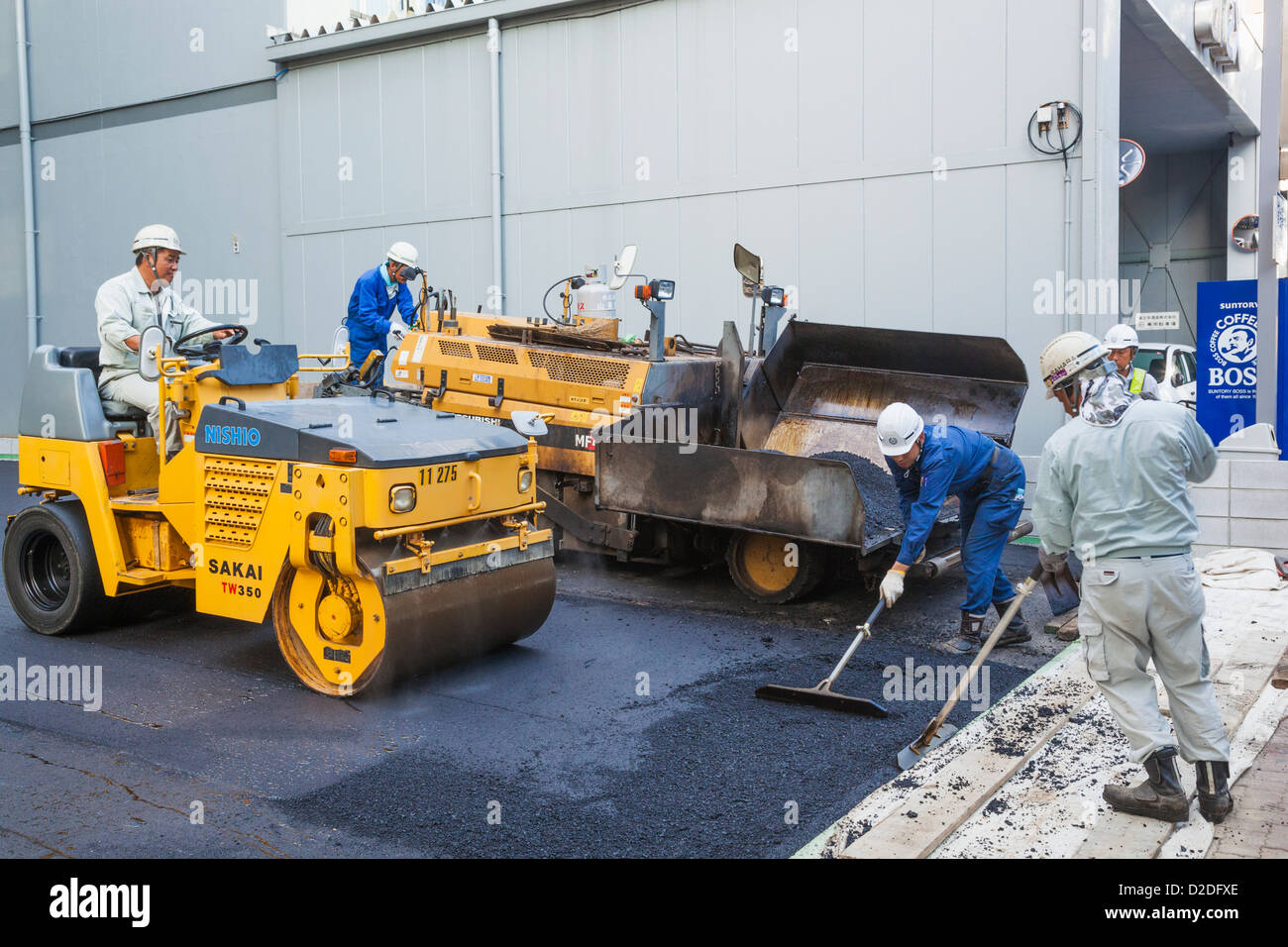 Japan, Honshu, Aichi, Nagoya, Construction Workers Laying Tarmac Stock ...