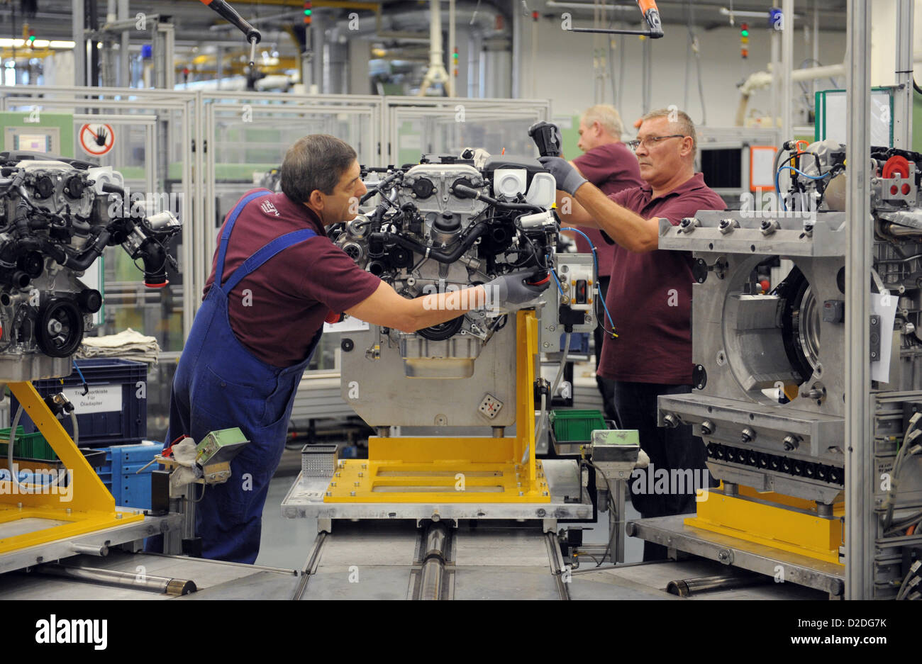 Two Daimler employees are installing an engine, on 20 September 2012 ...