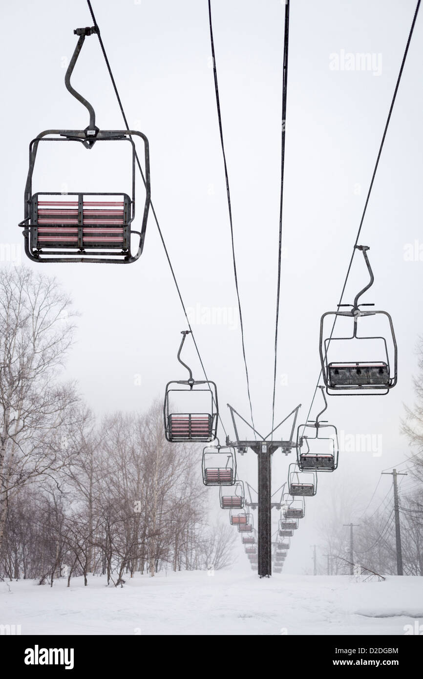 Empty chair lift in the mist and snow at Niseko ski resort in Japan ...