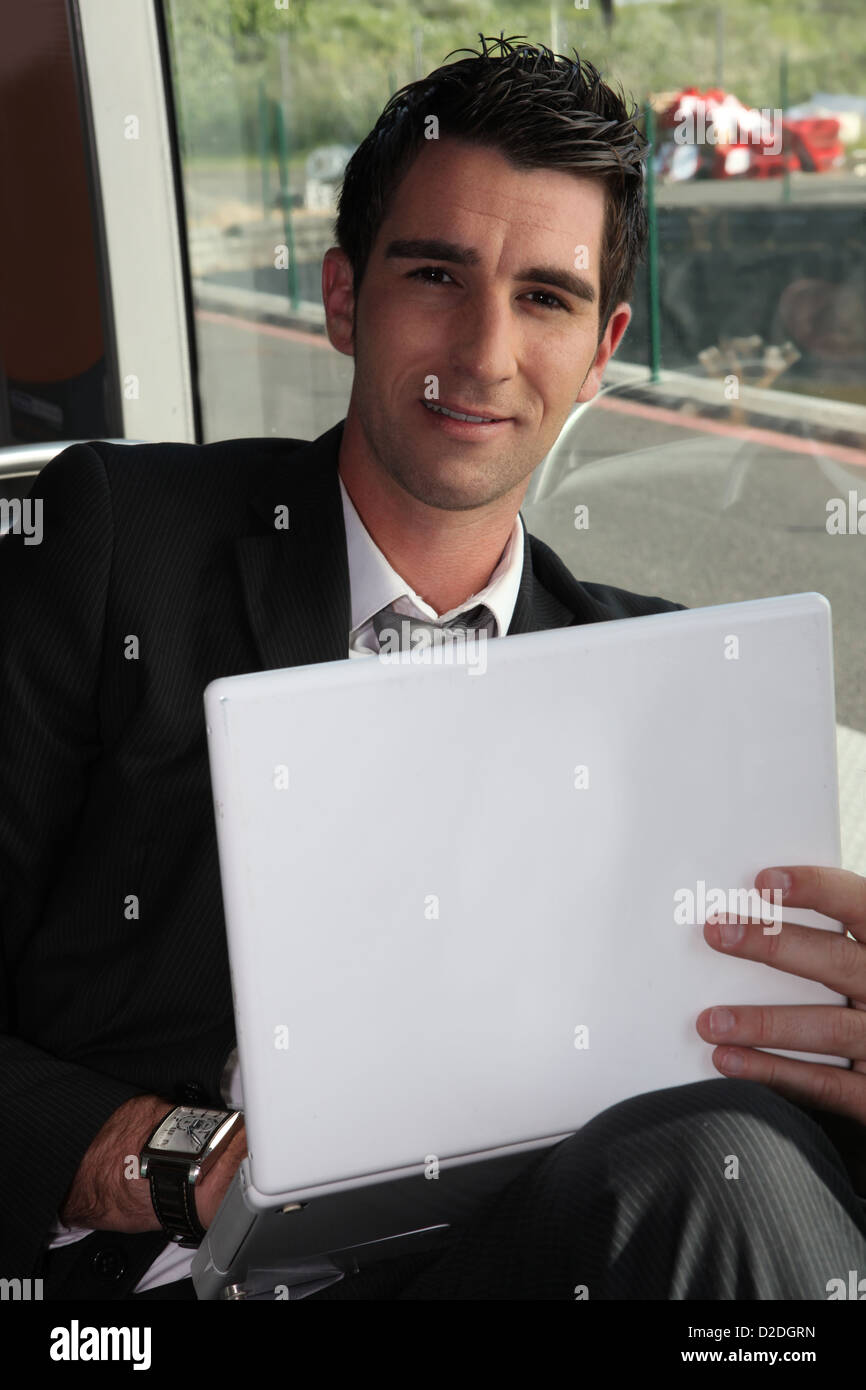 Commuter on a tram with a laptop computer Stock Photo - Alamy