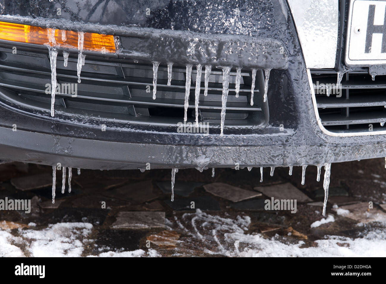 Front of black car grill covered in frozen sleet icicles depicting ...