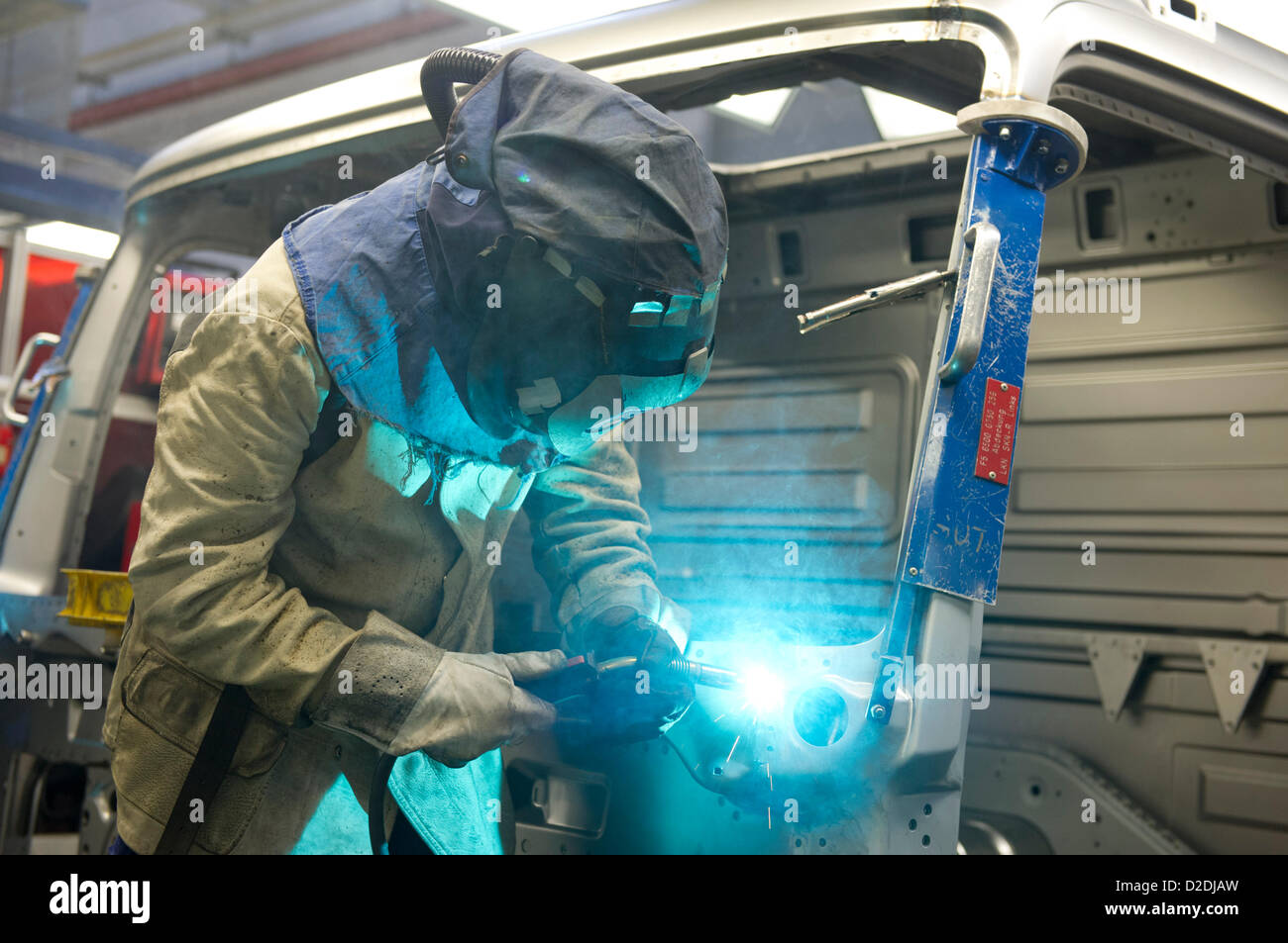 An employee is welding the body of a truck, on 8 February 2012, at the ...