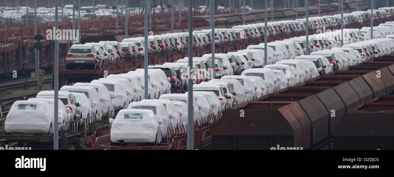 New vehicles in protection foil on a cargotrain at the train station of ...