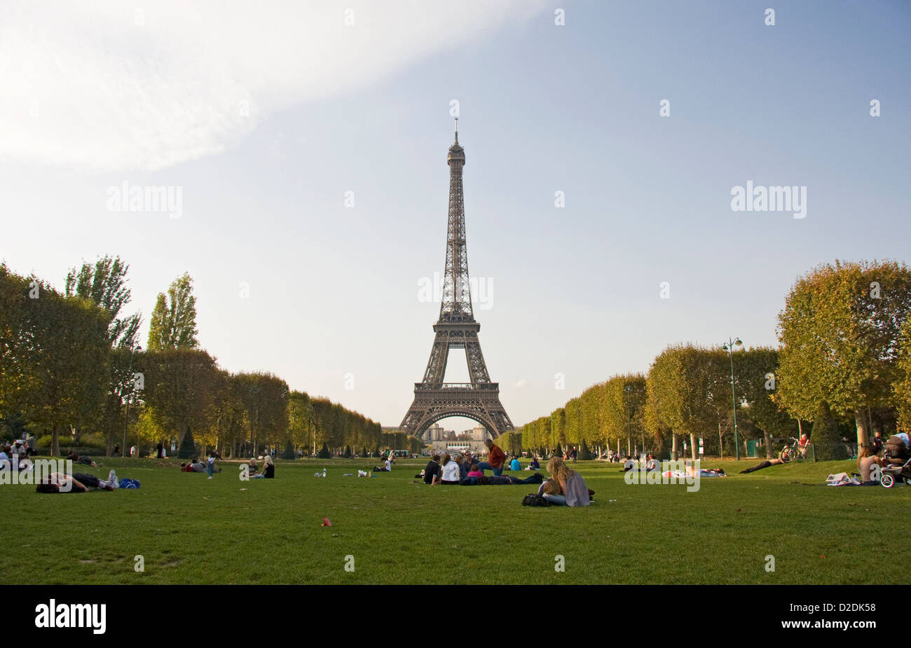 Parisians relax in the Parc du Champ de Mars, with the Eiffel Tower ...
