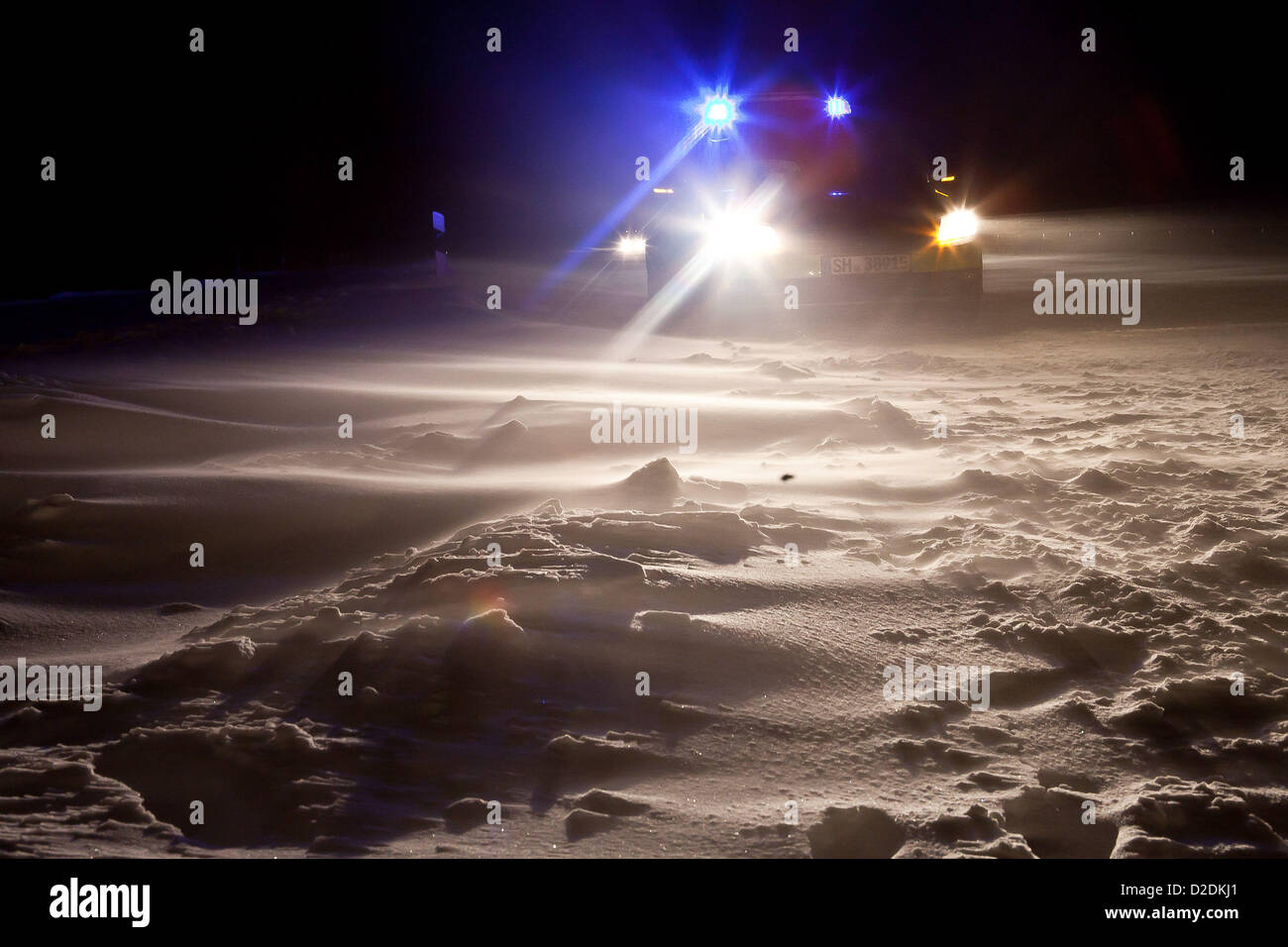 A police car drives on a snow-covered Autobahn 7 in Flensburg, Germany ...