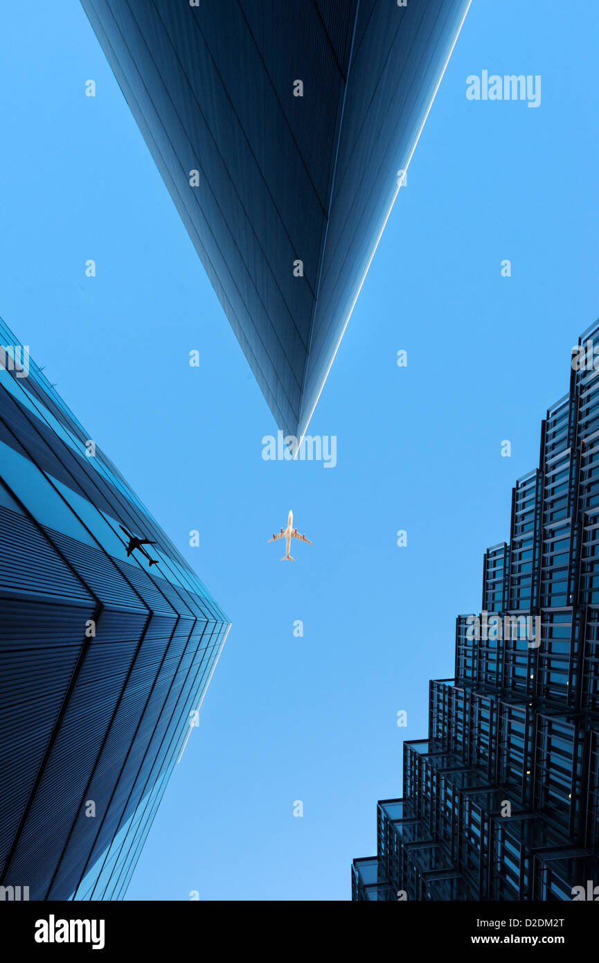Aircraft flying over skyscrapers London UK Stock Photo - Alamy