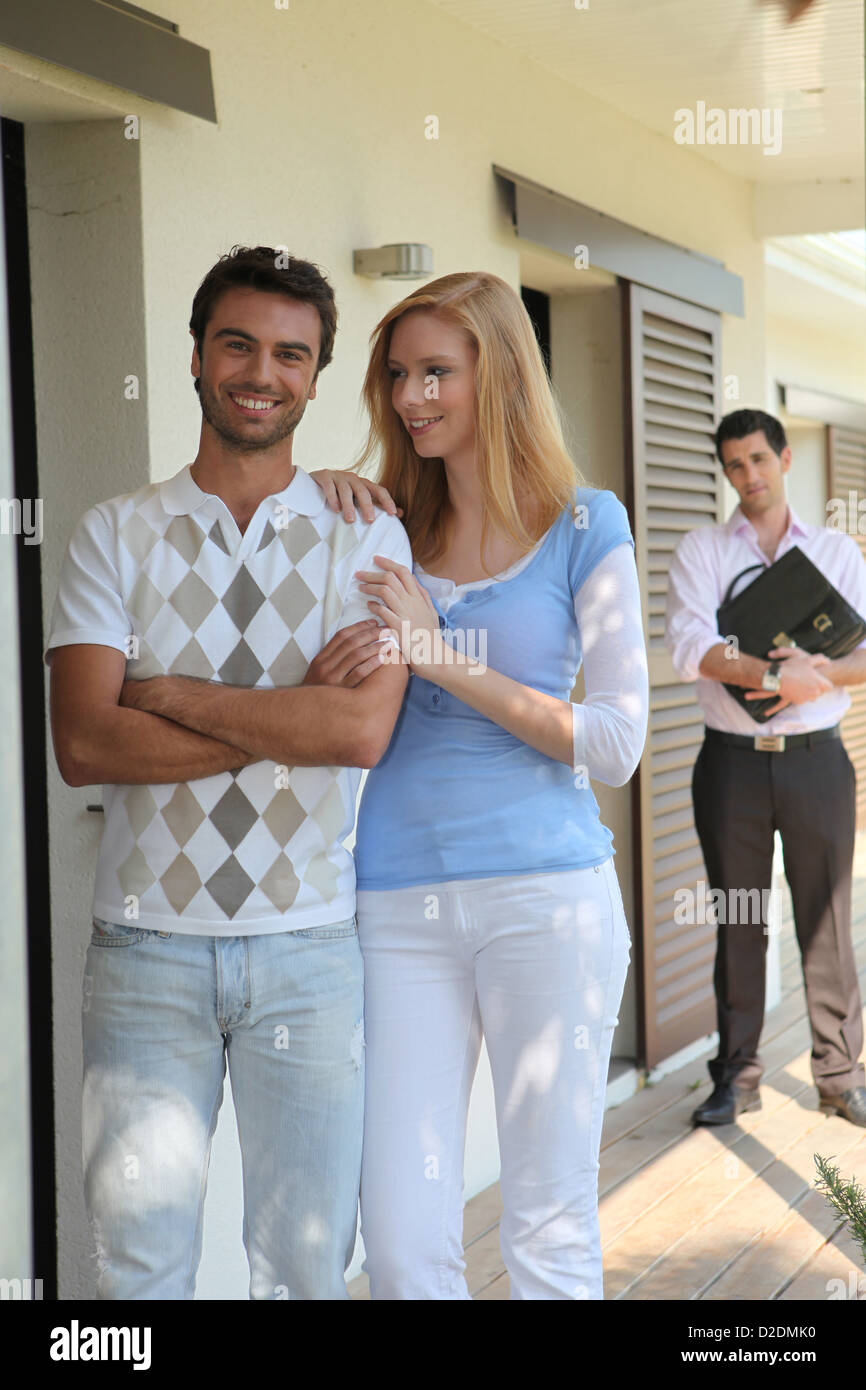 Couple in front of appartment Stock Photo - Alamy