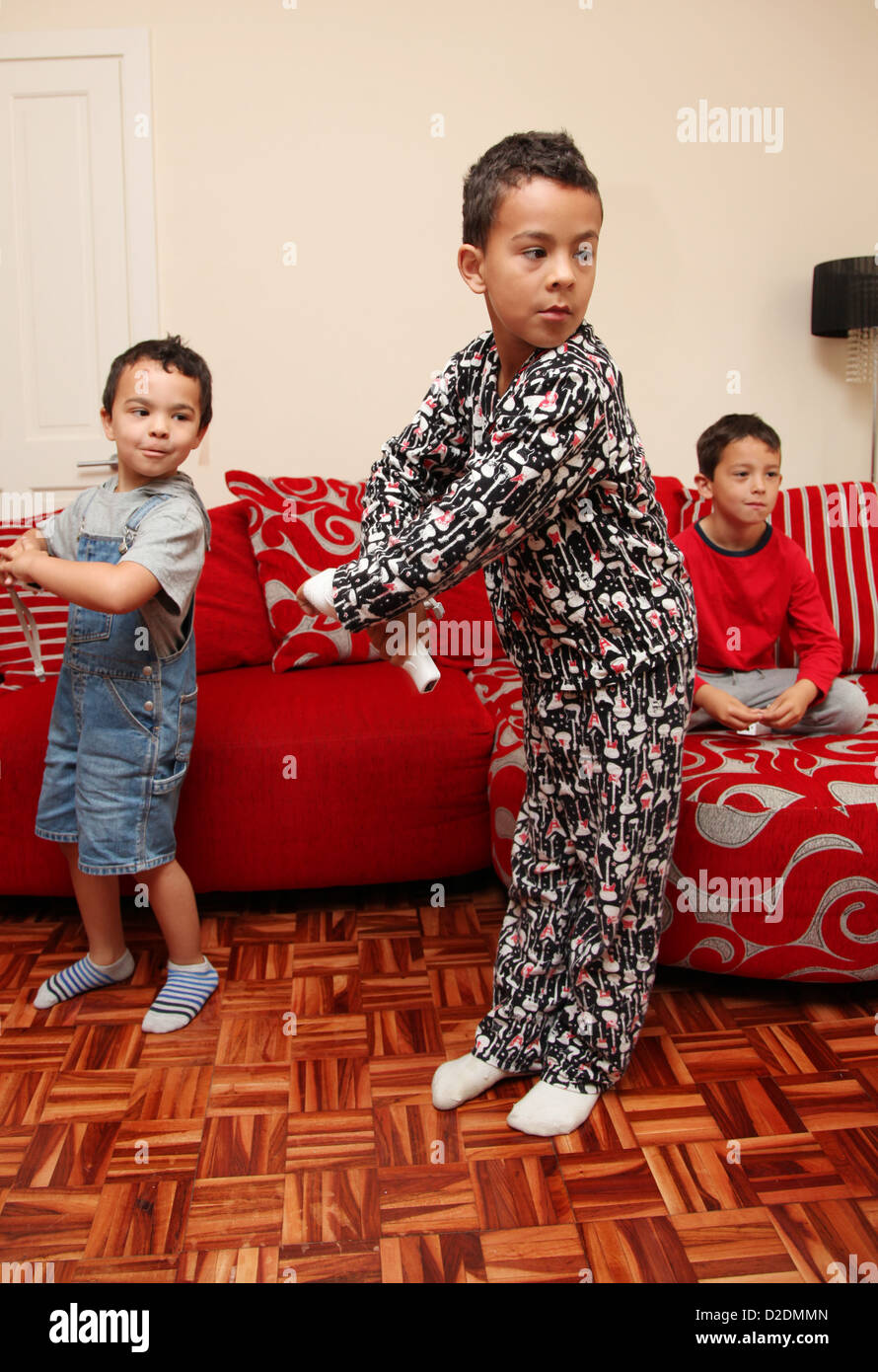 3 young boys playing indoors on the Wi Stock Photo - Alamy