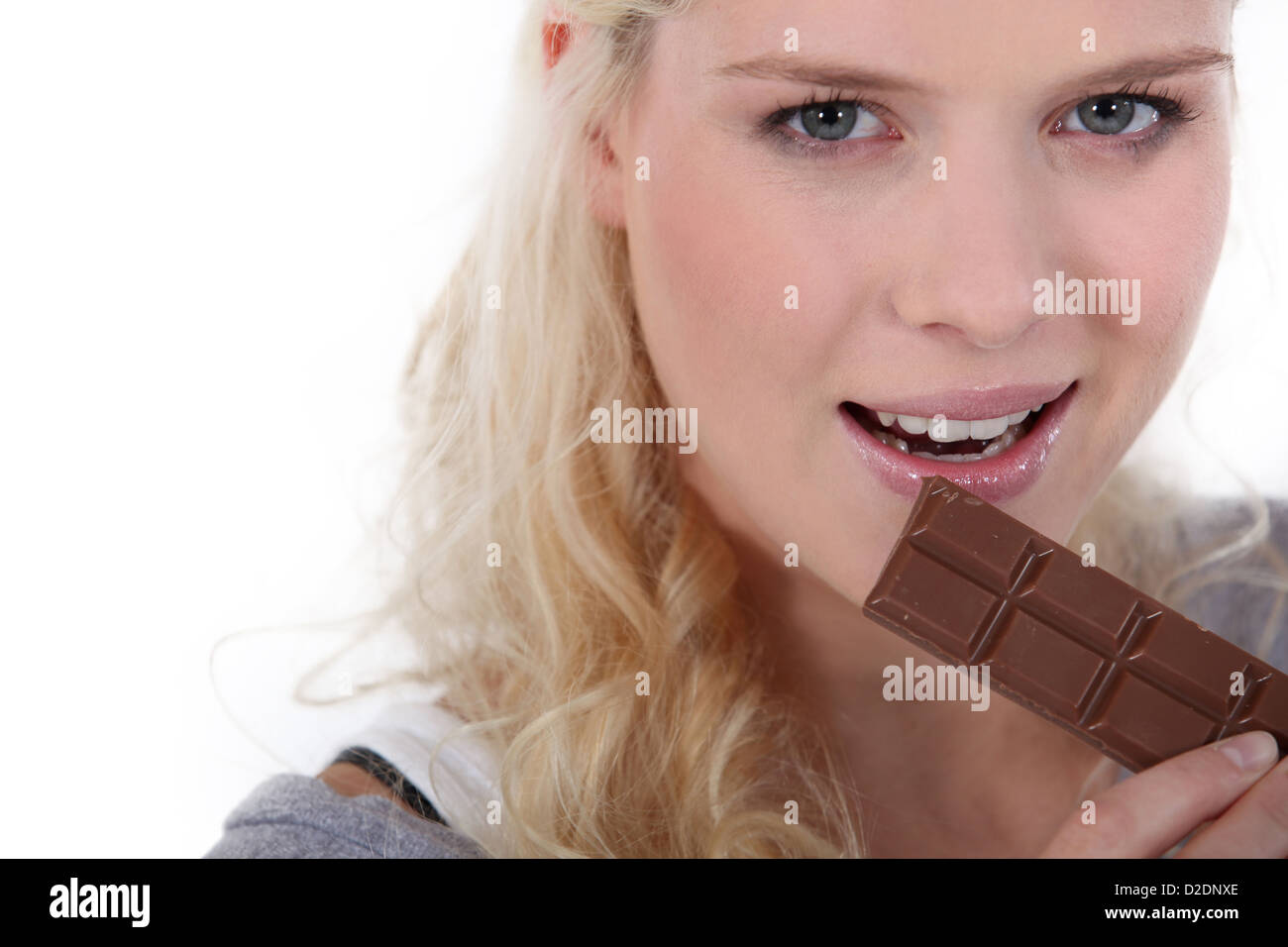 Girl eating chocolate Stock Photo - Alamy