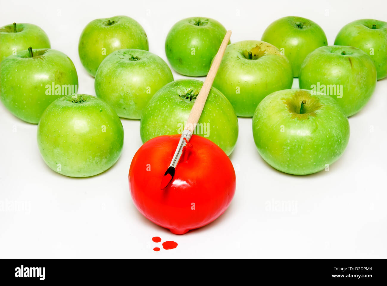 The apple painted by a red paint among unpainted apples Stock Photo - Alamy
