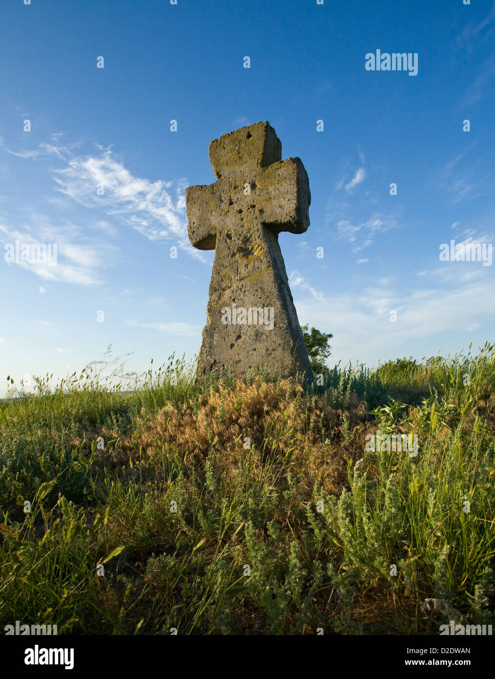 old stone cross.Green grass and blue sky Stock Photo - Alamy