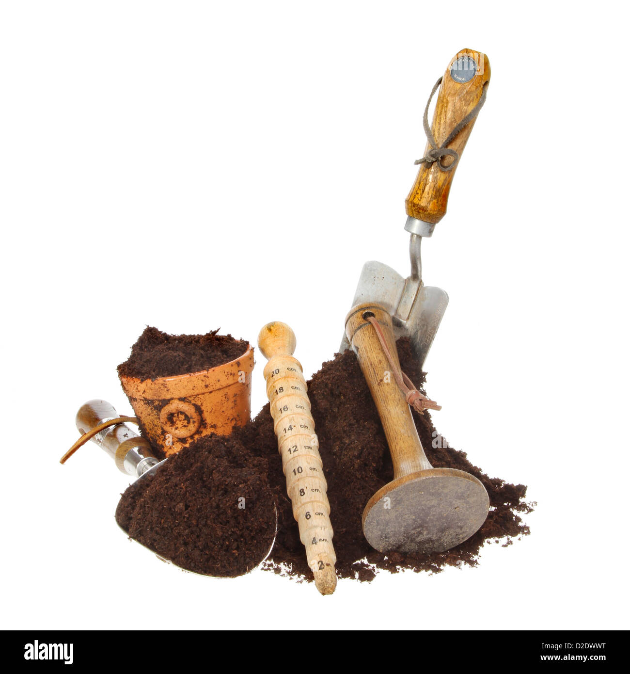 Garden tools and a pile of soil isolated against white Stock Photo - Alamy