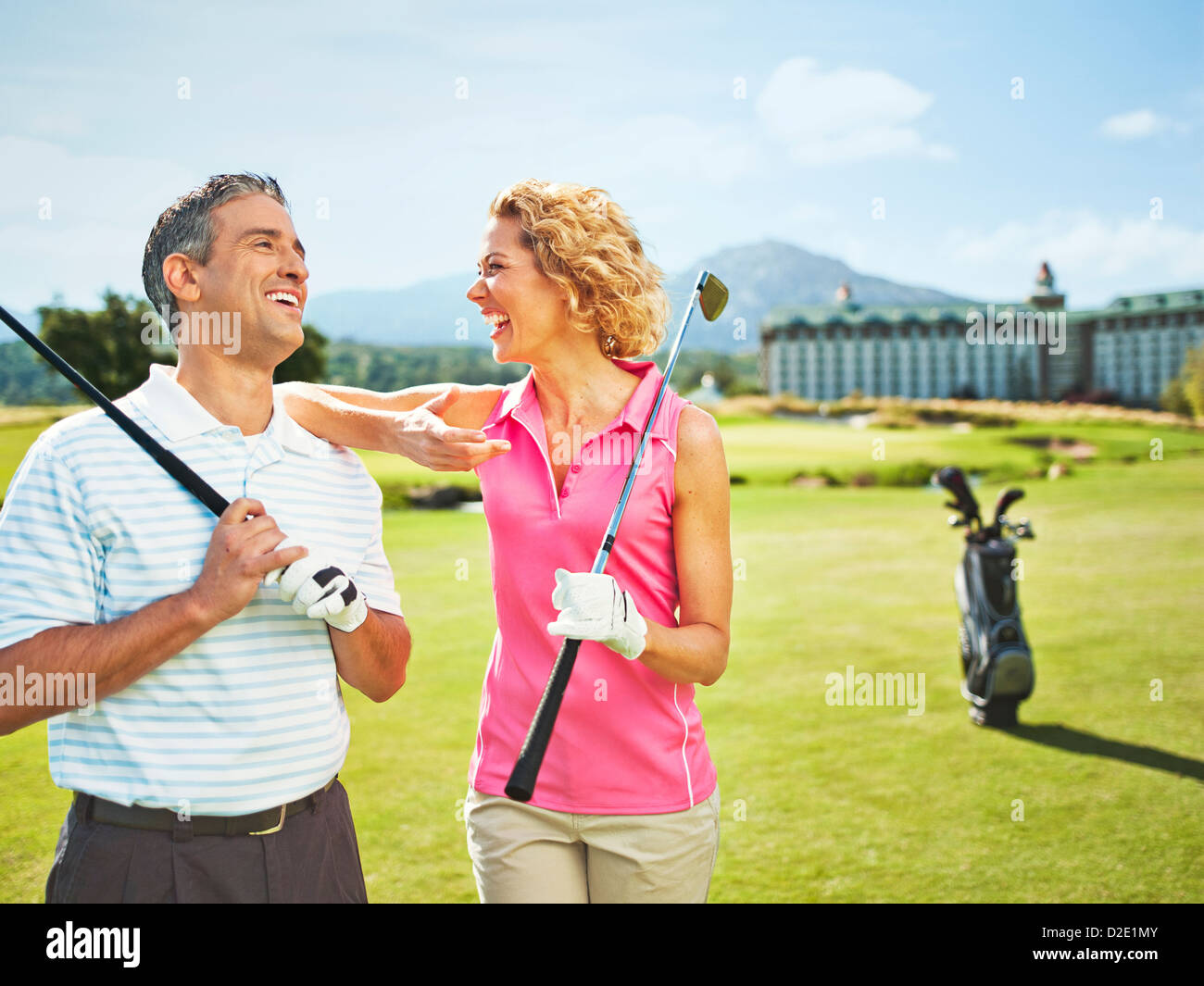 Happy couple talking in a golf course Stock Photo - Alamy