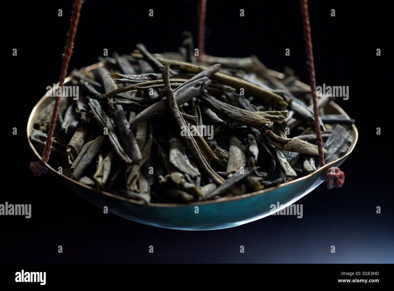 Berlin, Germany, tea leaves of green tea Liu An Gua Pian on a balance ...