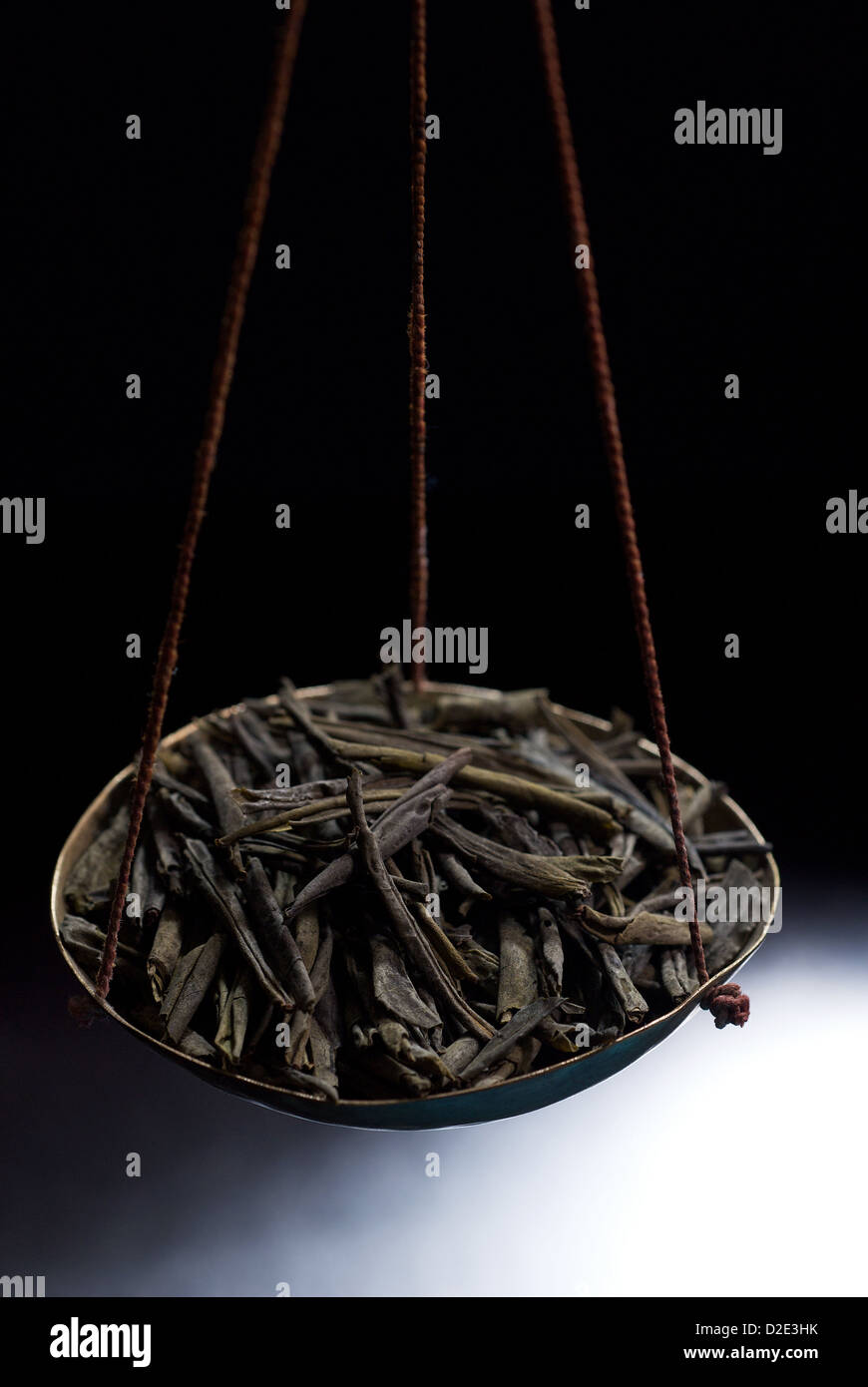 Berlin, Germany, tea leaves of green tea Liu An Gua Pian on a balance ...