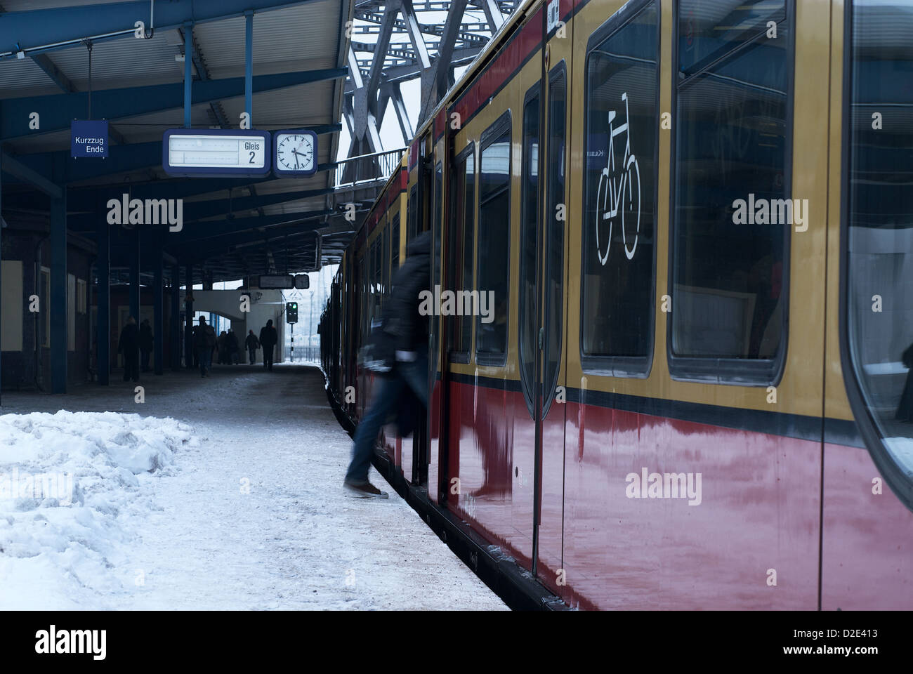 Berlin, Germany, a passenger gets into the train in a train station in ...
