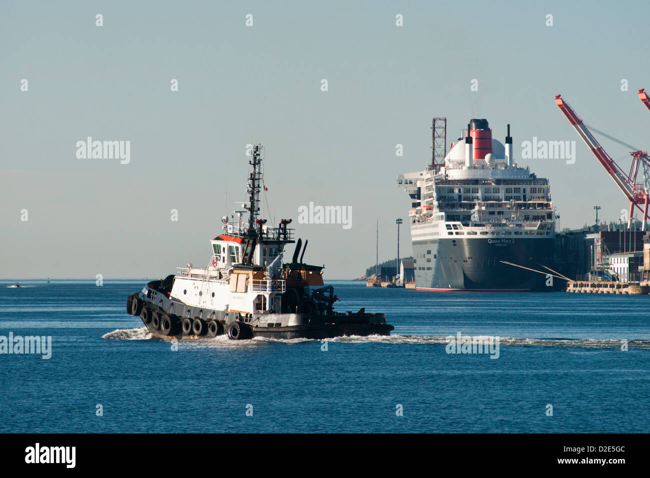 An Atlantic Towing tugboat passes the Cunard liner Queen Mary 2 in ...
