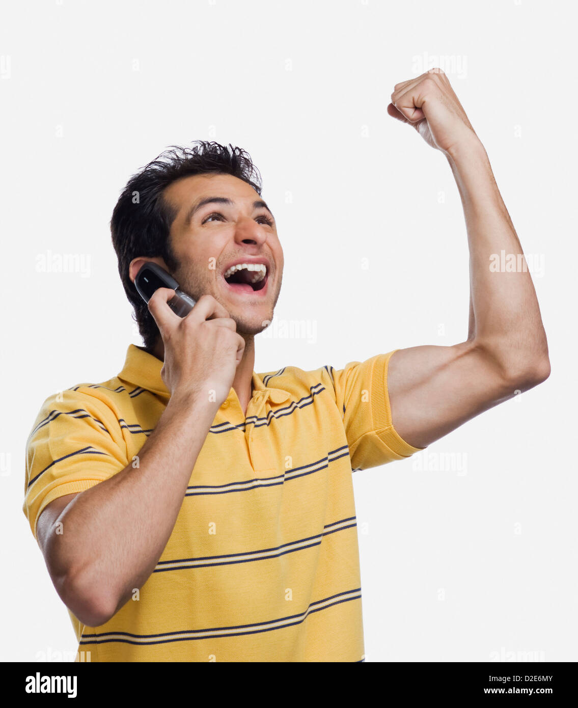 Close-up of a man talking on a mobile phone and clenching fist Stock ...