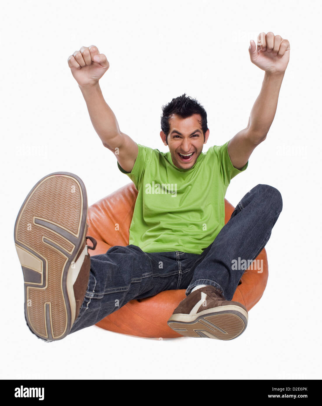 Portrait of a man cheering on a bean bag Stock Photo - Alamy