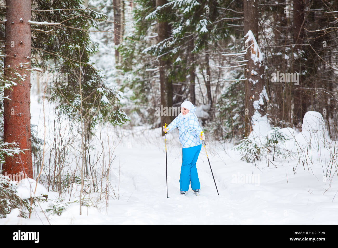 Female skier turning back skiing in winter forest Stock Photo - Alamy