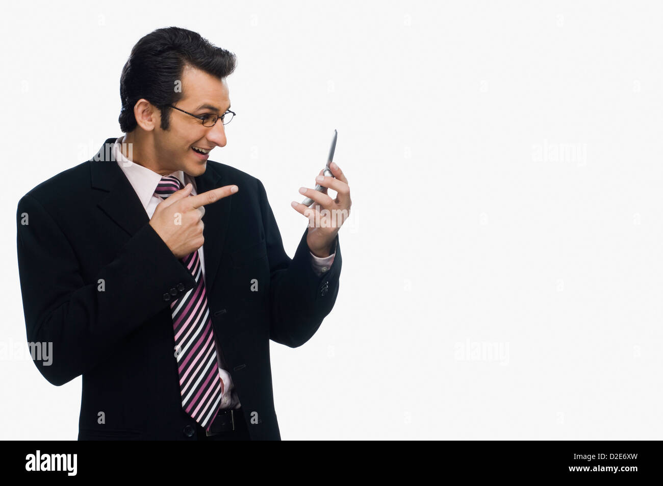 Businessman pointing at a mobile phone and smiling Stock Photo - Alamy